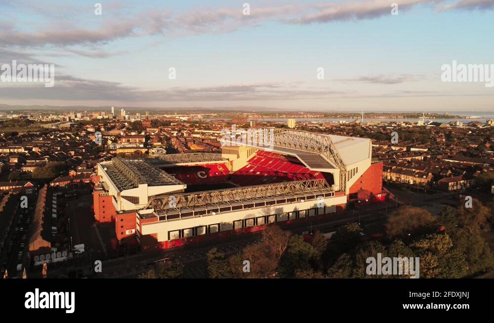 Iconic Anfield Liverpool football club stadium at sunrise aerial slow ...