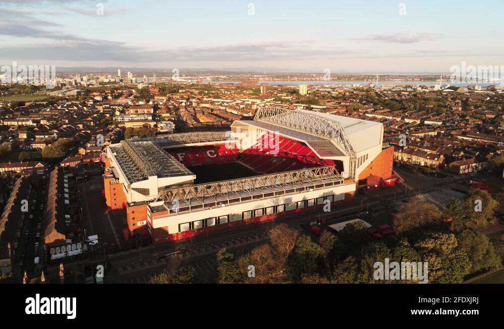 Iconic Anfield Liverpool football club stadium at sunrise aerial slow ...