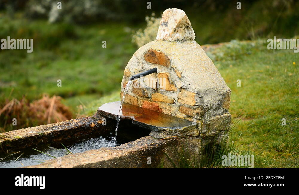Spring fountain of water near of the Cruz de Ferro, Spain. Camino de ...