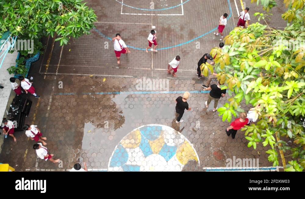 Drone flyover over school children playing soccer game, Indonesia Stock ...