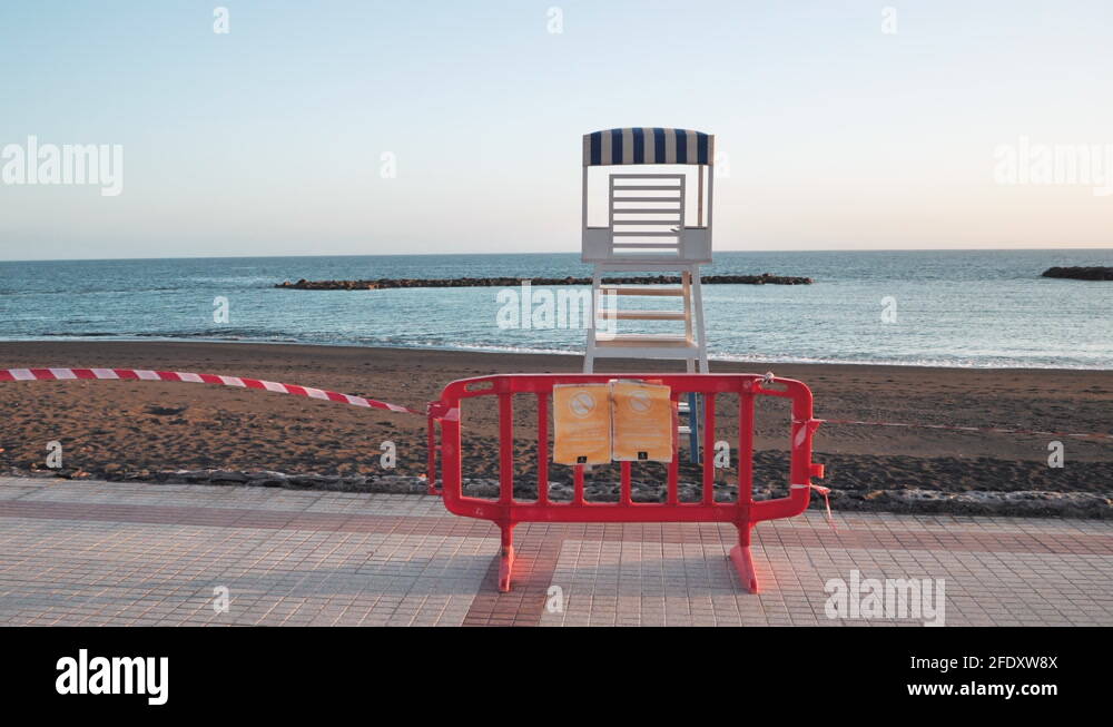 A baywatch chair behind the fence and security seal tape locking the ...
