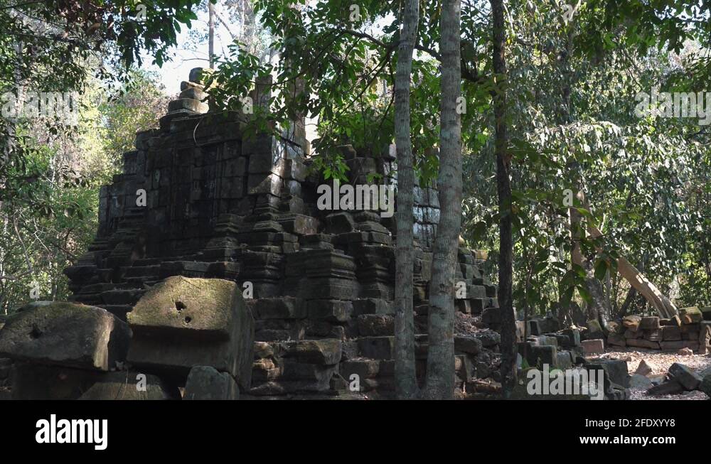 Pan Across an Ancient Crumbling Structure in the Jungle Near Angkor Wat ...