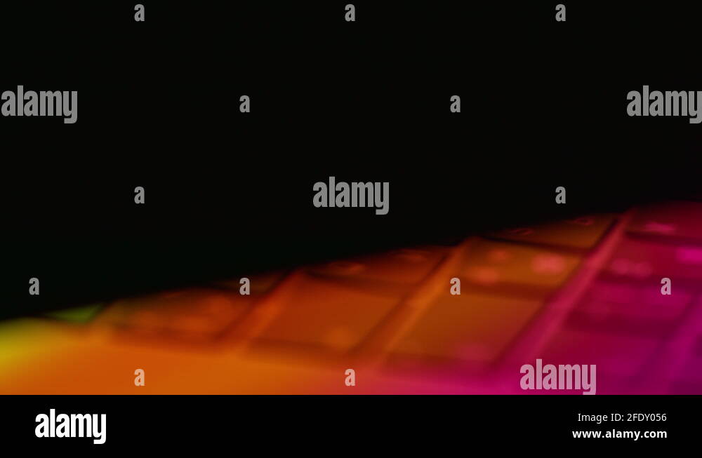 Rotating close-up of a modern laptop keyboard and trackpad under a ...