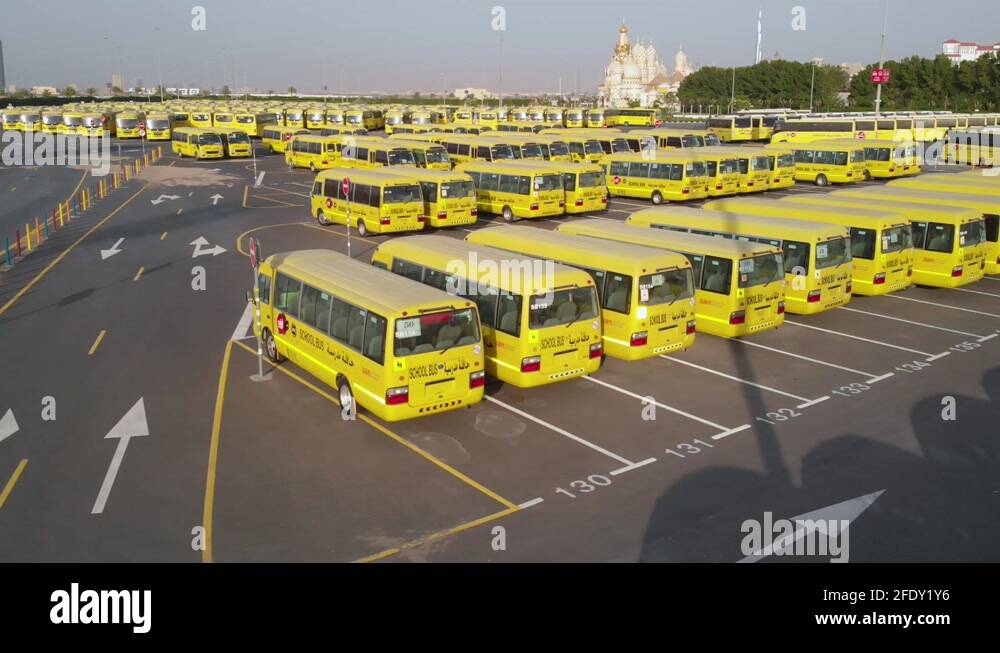 Yellow school buses in parking lot, rear aerial shot Stock Video ...