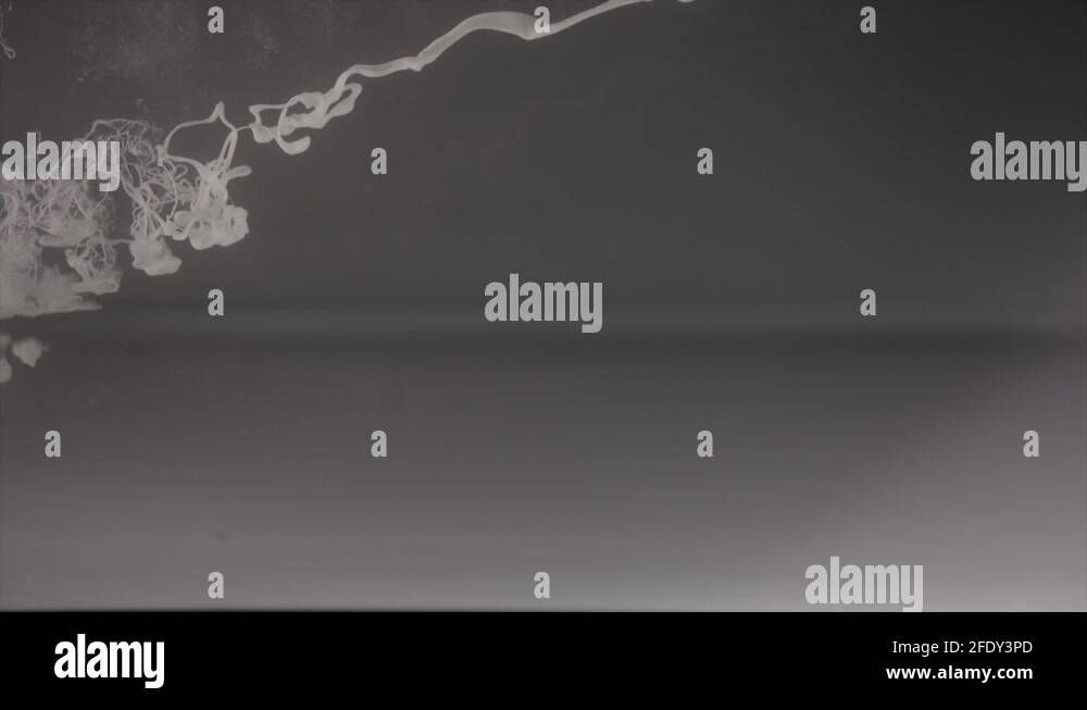 Cloud tank with rolling fog and ink shot against black, on and in water ...