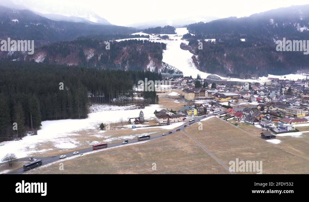 High aerial view of downtown Nassfeld with buses and cars entering town ...
