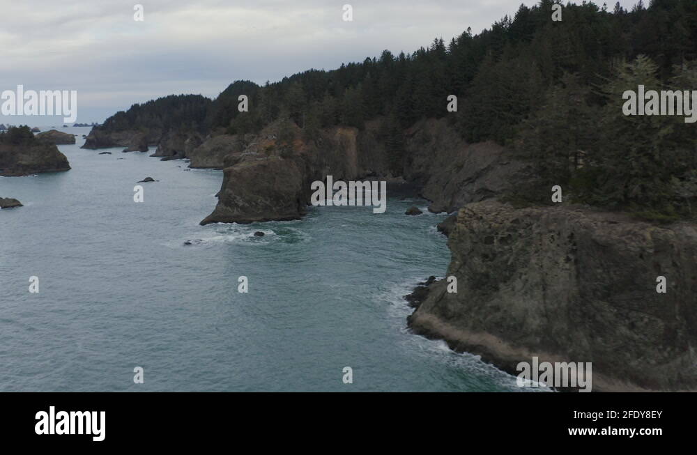 Cinematic aerial flyover of scenic Oregon coast in Pacific Northwest ...
