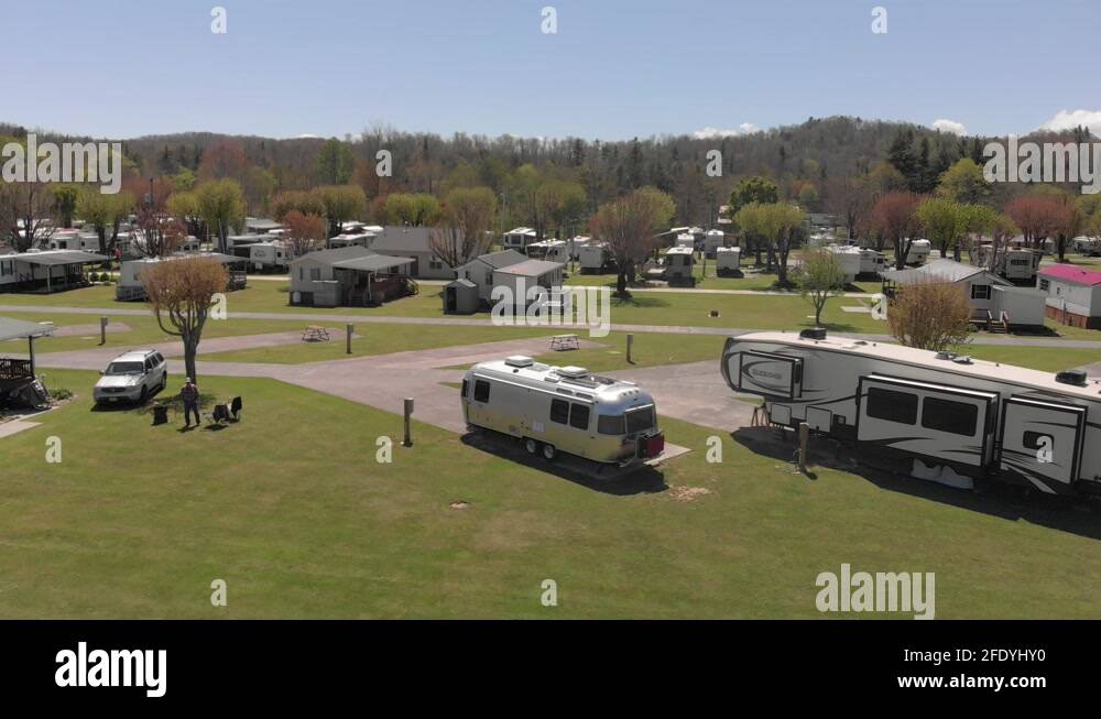 Picturesque view of RV campground of fifth wheels, motorhomes and park ...