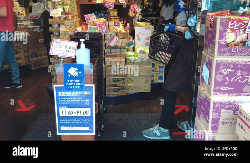 Japanese Shop Keeper Using Alcohol To Clean And Disinfect The Handles ...