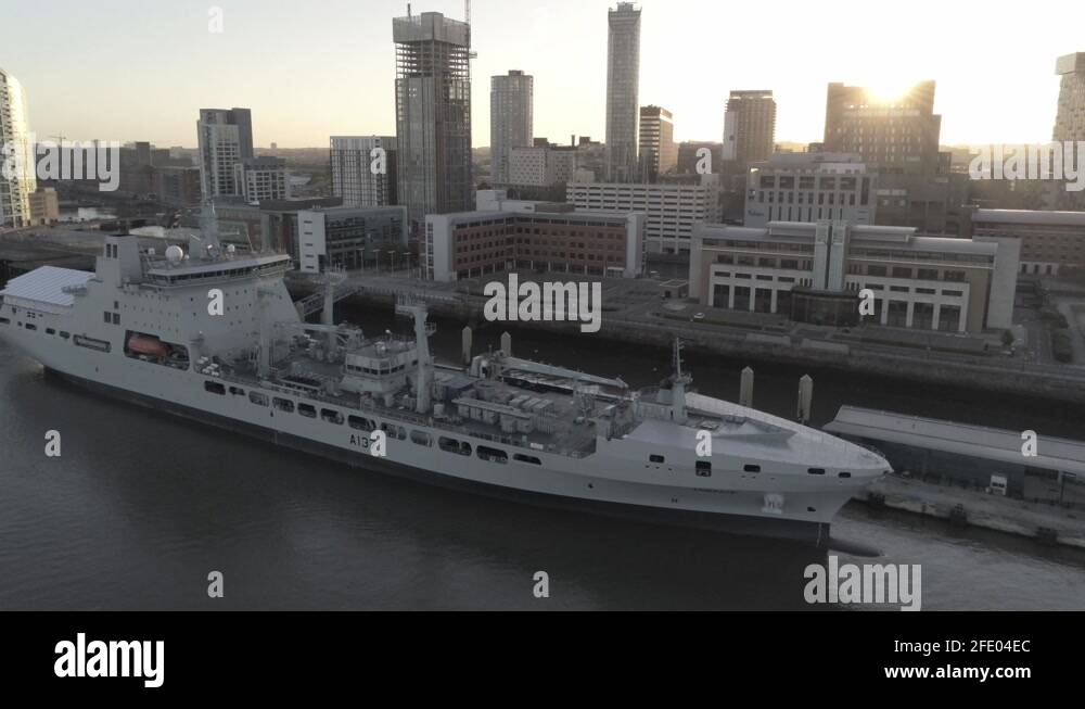 Liverpool waterfront sunrise high rise buildings and military navy ship ...