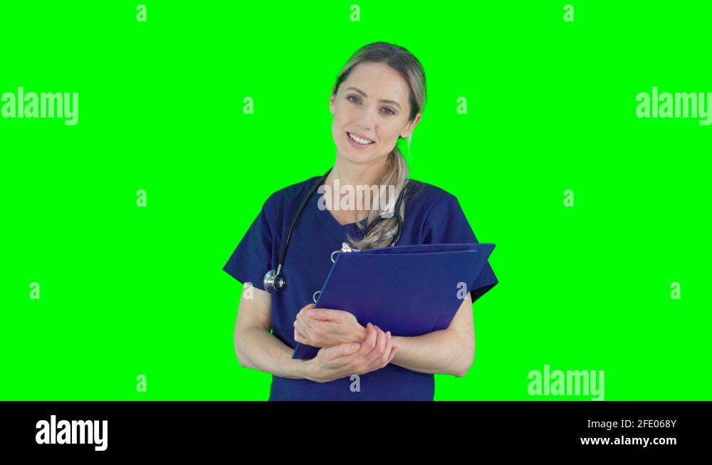 4K portrait of female nurse doctor smiling on green screen isolated ...