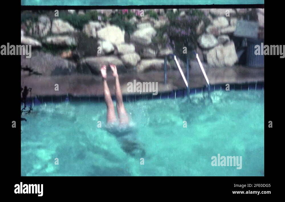 1960s: Girl dives into pool. People swimming in pool. Girls dive in ...