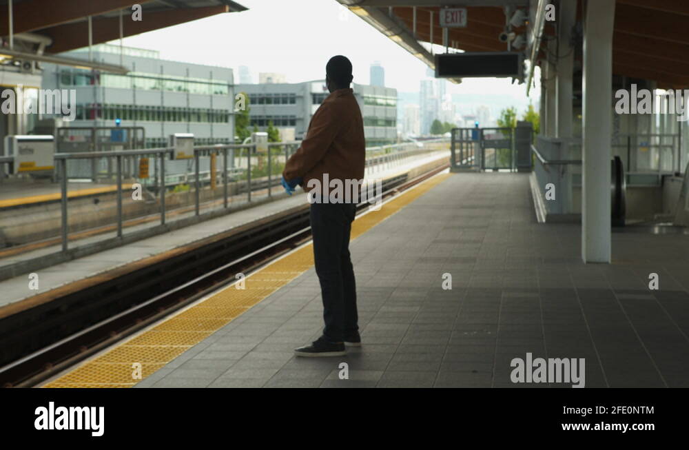 African American black man waiting for train on exterior platform ...
