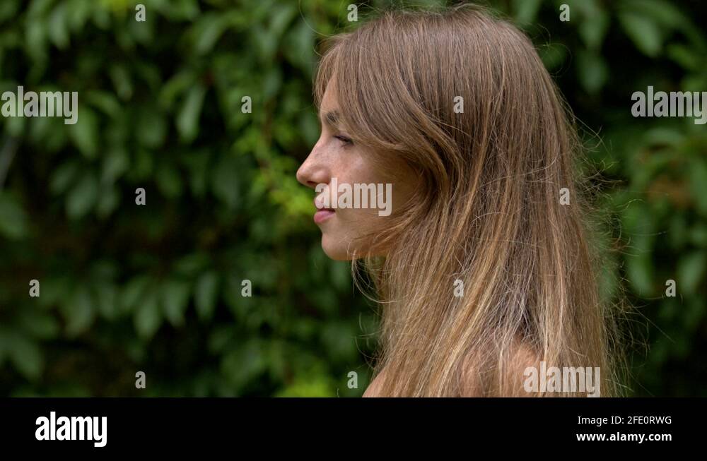 Profile of an attractive young woman with a serious expression on her ...