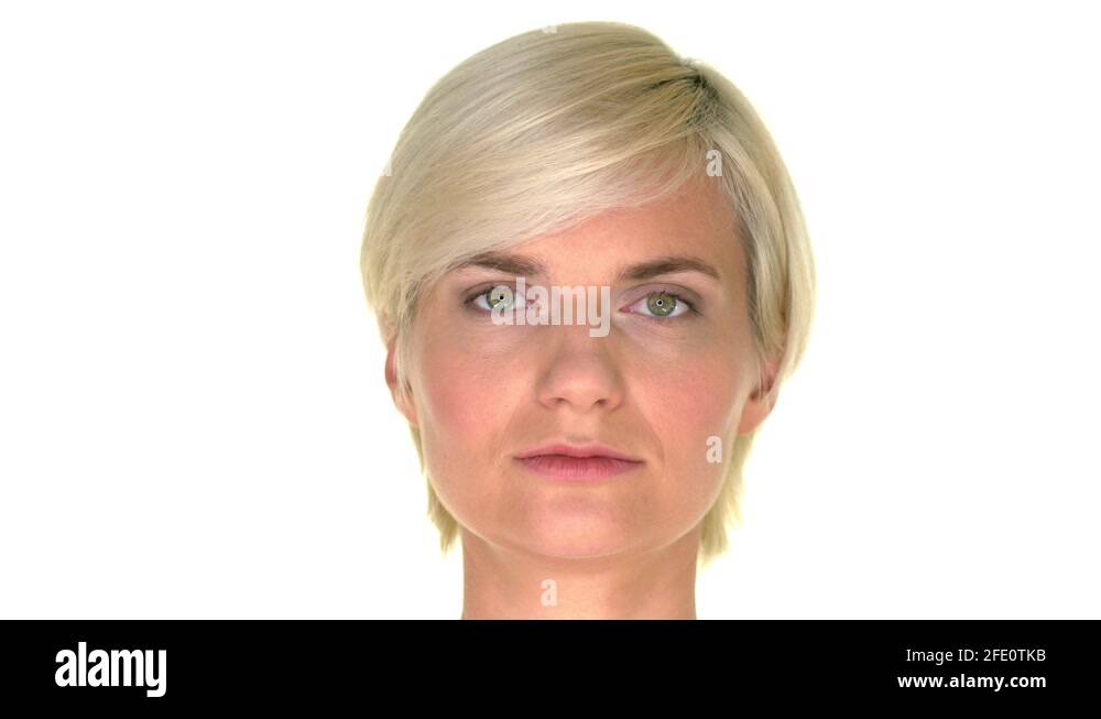 Woman with a calm facial expression closing her eyes on a white studio ...