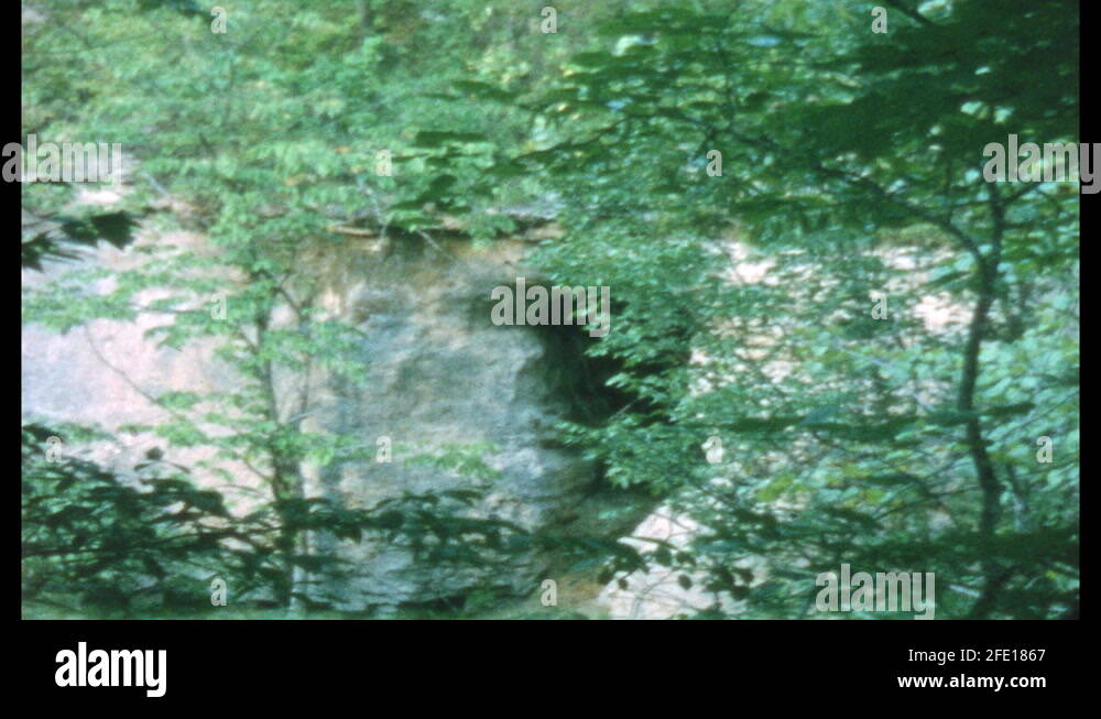 1960s: Cave entrance behind trees. Multi-car parking structure. Car ...