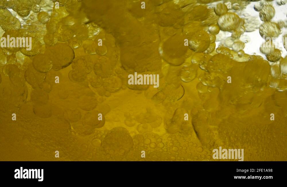 Bubble structure of air of sunflower oil on a white moving background ...