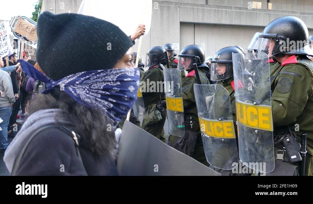 Angry black woman screaming at embarrassed white police officer Stock ...