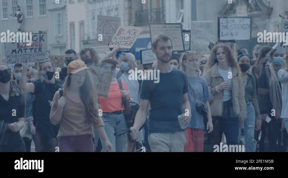 Crowd of people marching with signs in city at Black Lives Matter march ...