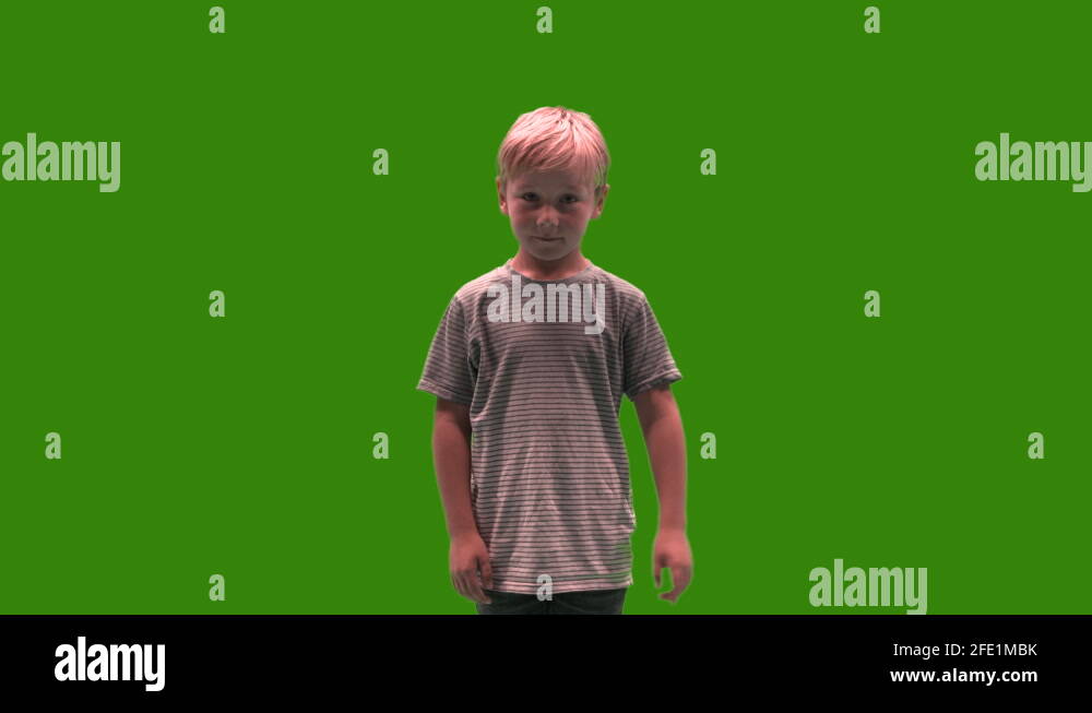 Young boy on green screen pointing right down to approve something ...