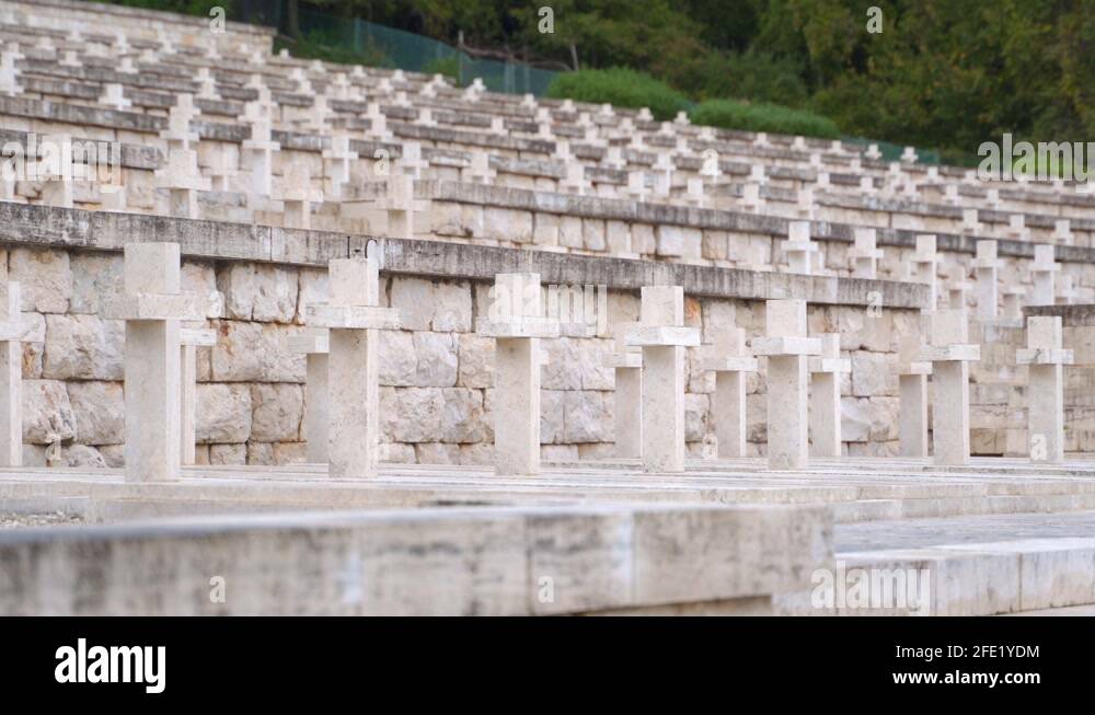 Rows of white small simple stone crosses on hillside at Polish cemetery ...