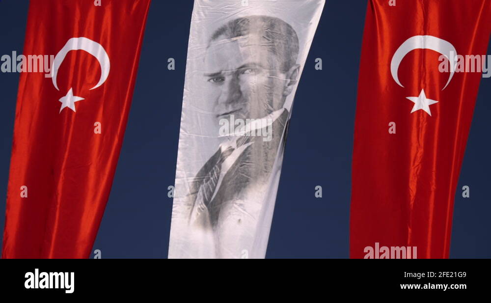 Two Turkish flags and Ataturk portrait slowly weaving on the wind on ...