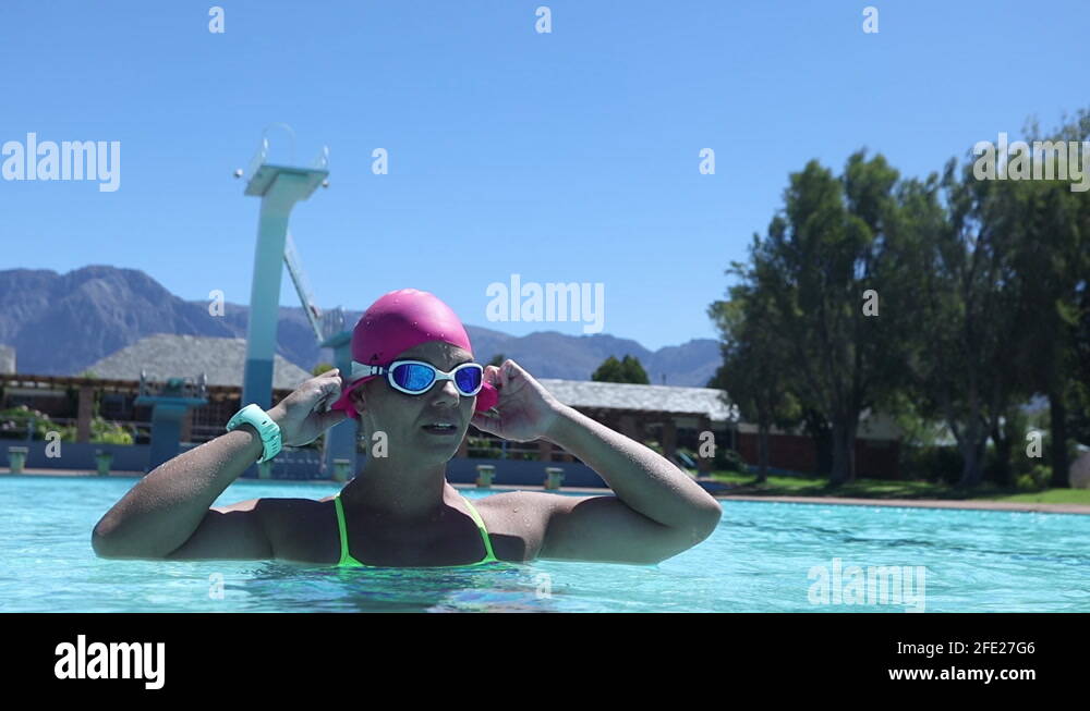 footage of a female swimmer swimming laps in an outdoor pool using the ...