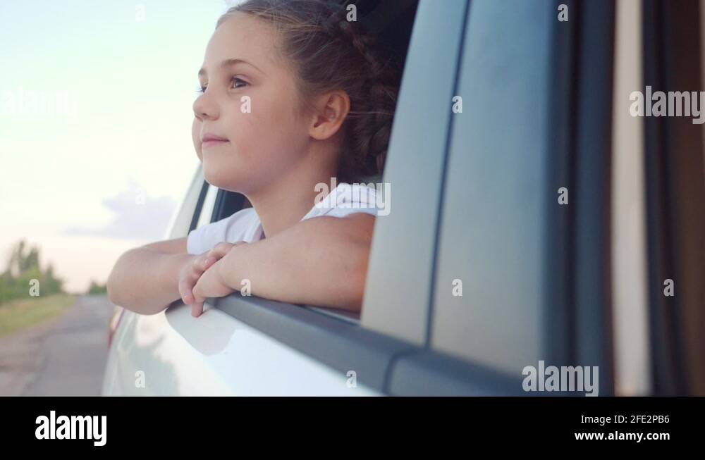 happy girl kid child smile leaned out of a car window. happy family ...