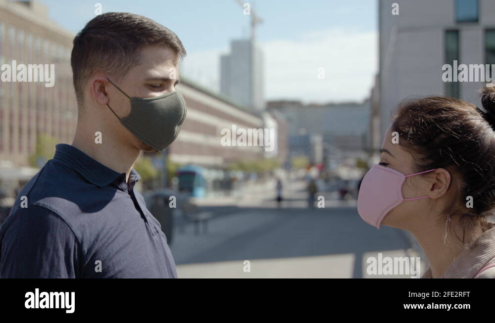 A mask wearing couple removing masks and kissing Stock Video Footage ...