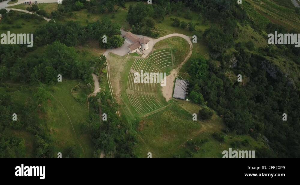 Historic outdoor amphitheatre in countryside, lowering aerial bird's ...