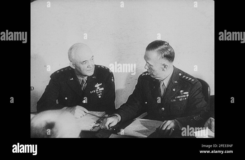 1940s: Officers talk seated around table. Officers talk standing in ...