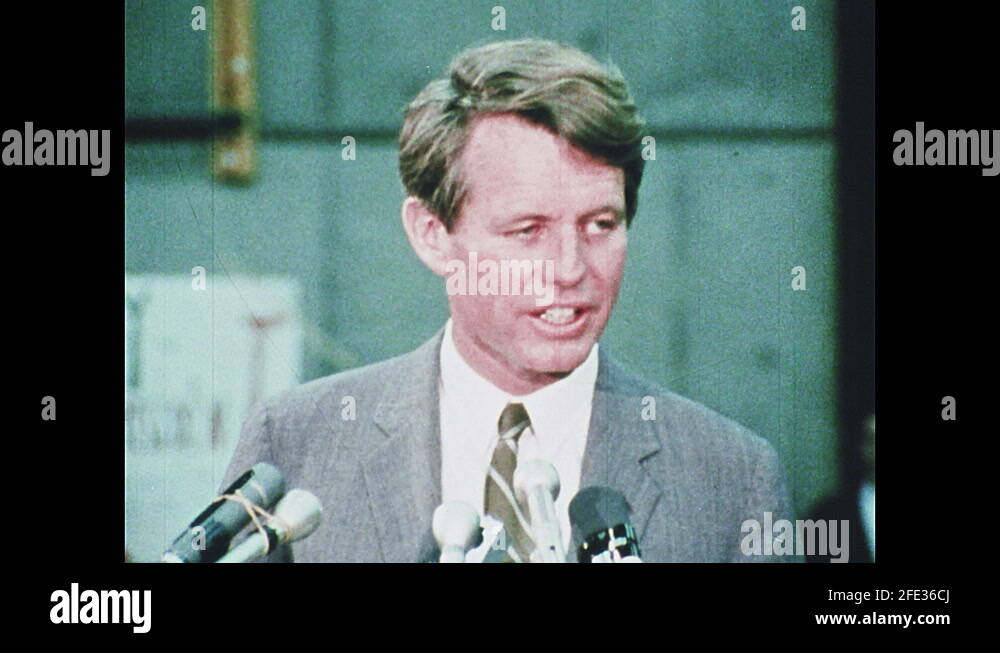 1960s Oregon: Audience claps and cheers. Robert F. Kennedy stands at ...
