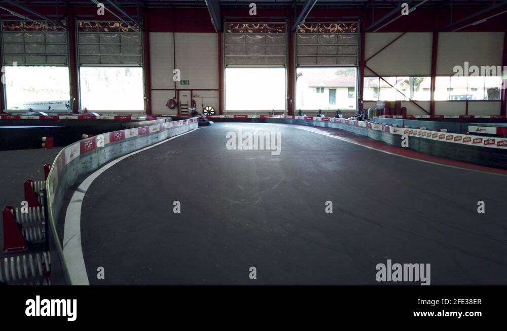 Close up footage of indoor Go karts driving fast through the corner ...
