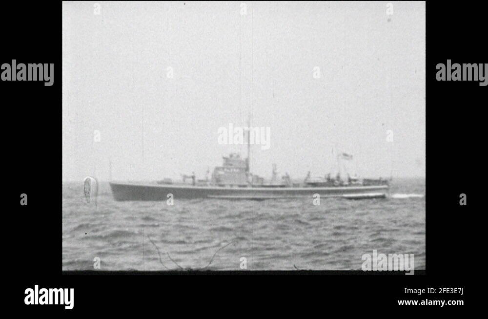 1940s: military ship sails over ocean waves, sailors on deck as ship ...