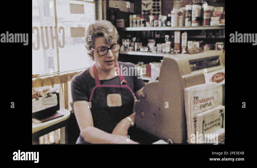 1970s: woman behind cash register talking, owner of local grocer ...