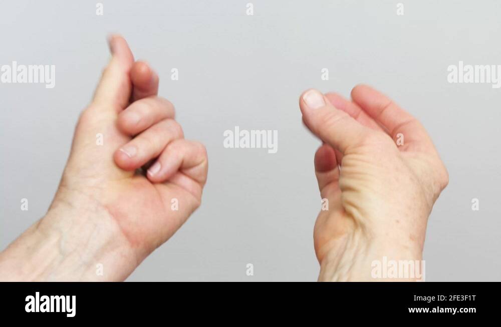 A close up view of two hands snapping isolated in front of a white ...