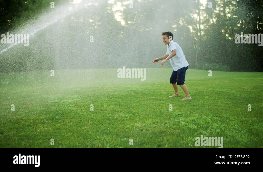 Happy boy playing water sprinkler Stock Videos & Footage - HD and 4K ...