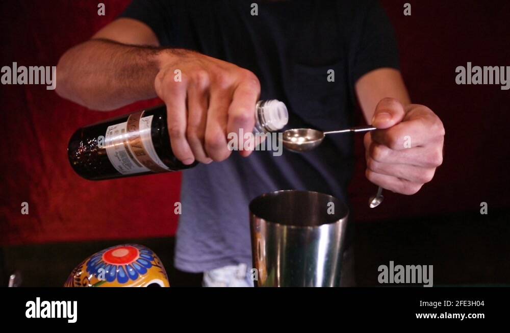 Pouring Agave Sec, making margarita, measurement, cocktail bar, red ...
