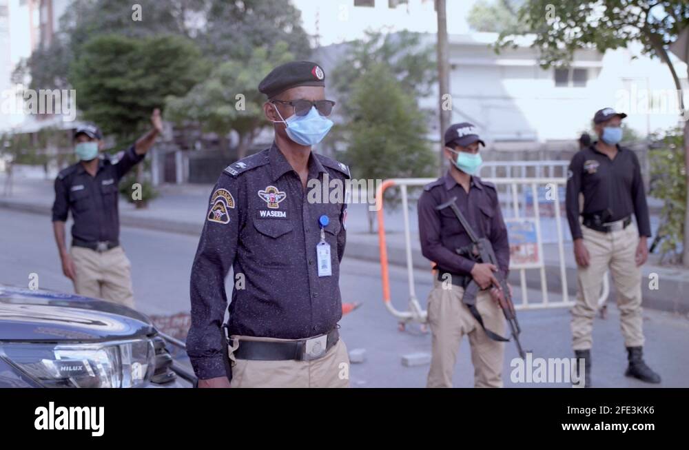 Smart Police officer standing with his squad wearing face masks during ...