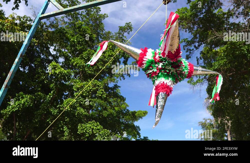 Mexican piñata hanging on a pole with a pulley, sunny day Stock Video ...