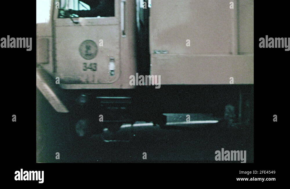 1970s: garbage truck drives by, mailman walks down sidewalk, garbage ...
