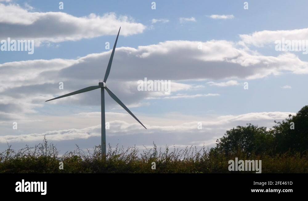 Wind Turbine spinning in the wind in front of the clouds to produce ...