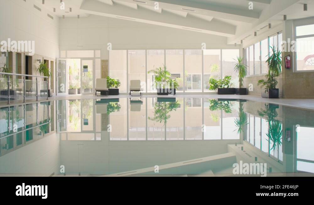 Massive indoors pool inside a luxurious Villa with shezlong chairs and ...