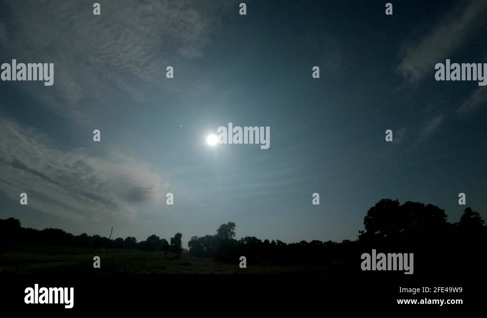 Time lapse of full moon crossing the night sky with clouds passing by ...