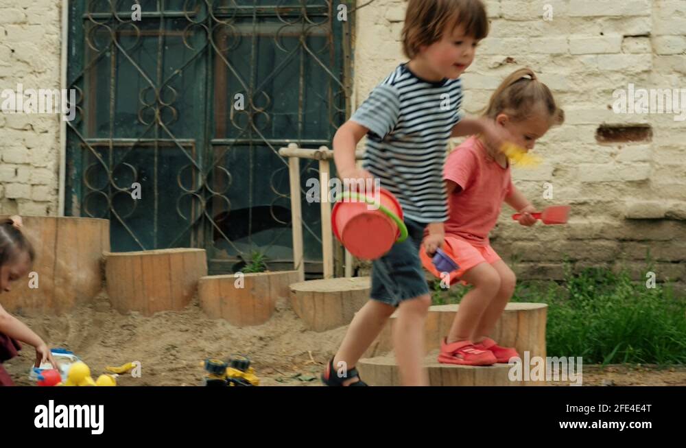 Little kids playing on sandy playground Stock Video Footage - Alamy