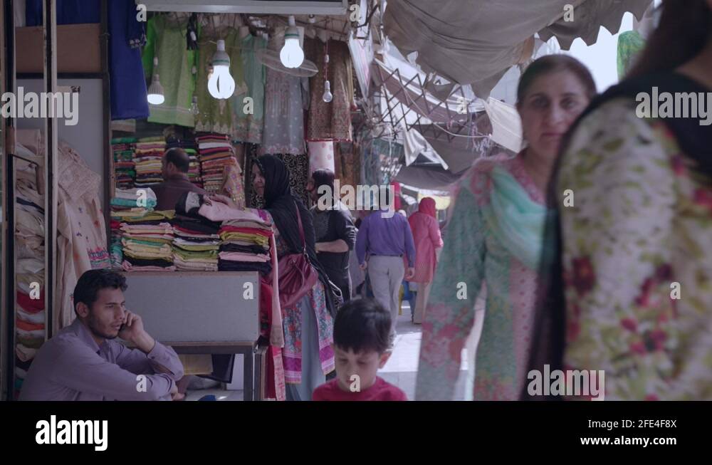 Traditional Indian / Pakistani bazaar (cloth market) as women select ...