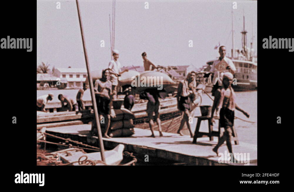 1970s: People load sacks onto boat. Map of Thailand, Malay Peninsula ...