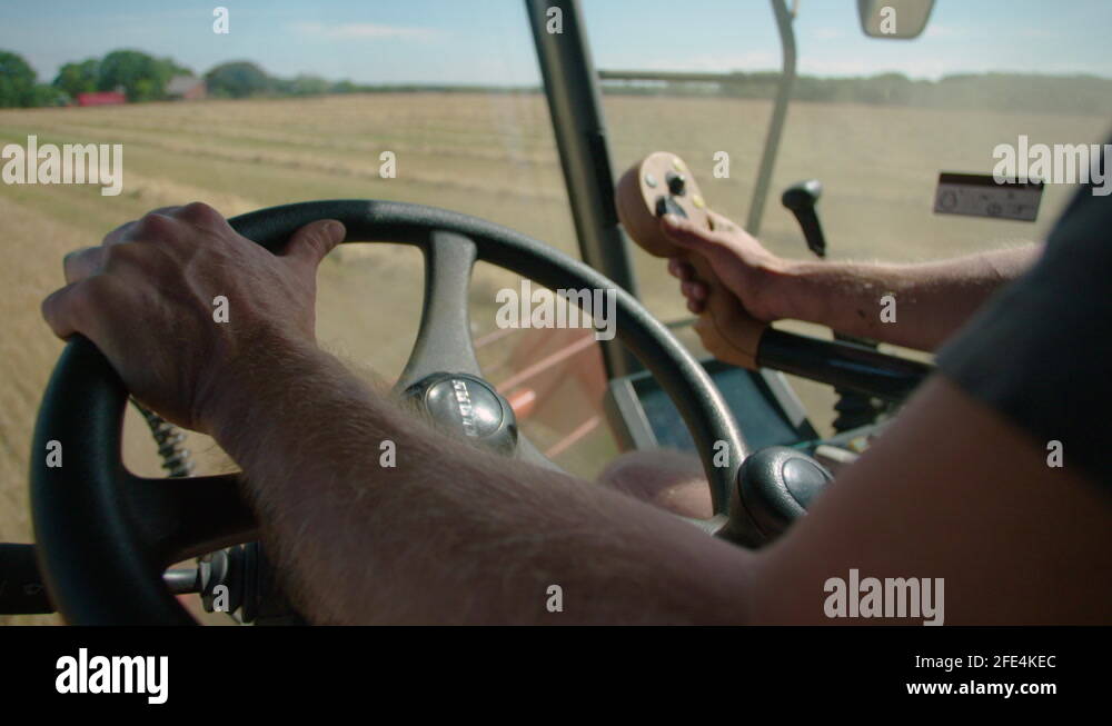 Farmer driving a harvester hands on stearing wheel Stock Video Footage ...