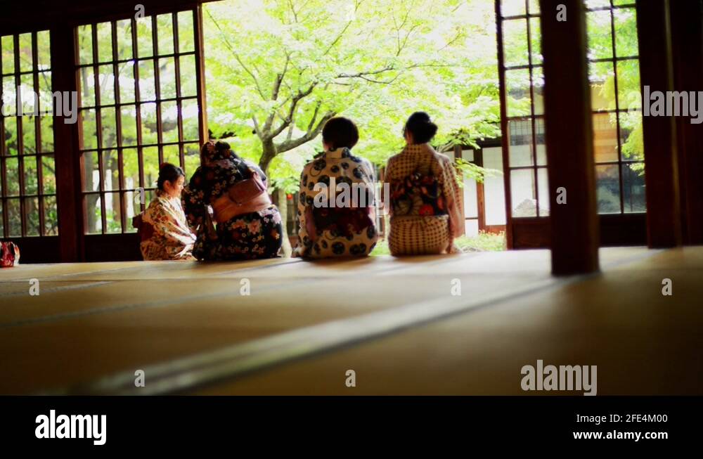 women wearing a kimono sitting a the window of a traditional japanese ...