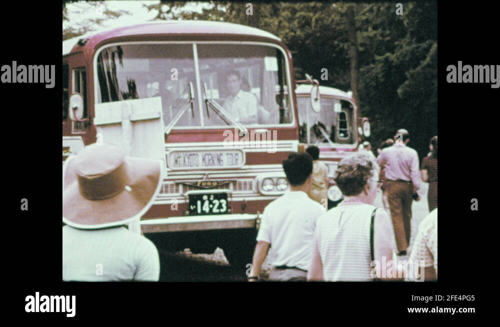 1970s:Bus begins pulling out of parking lot. Young American boy chases ...